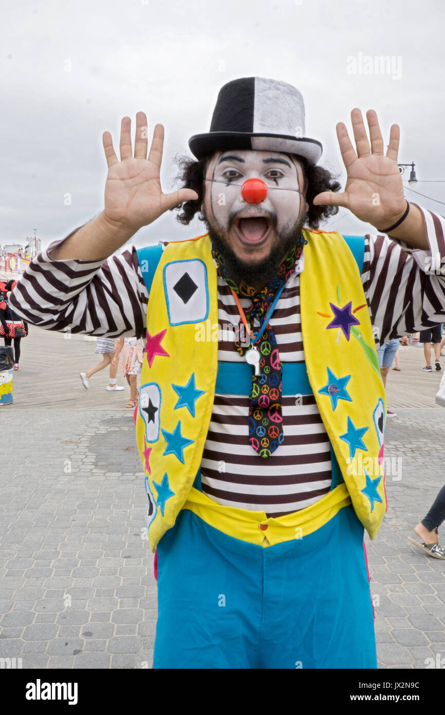 Posed portrait of a clown in costume and face paint busking on the ...