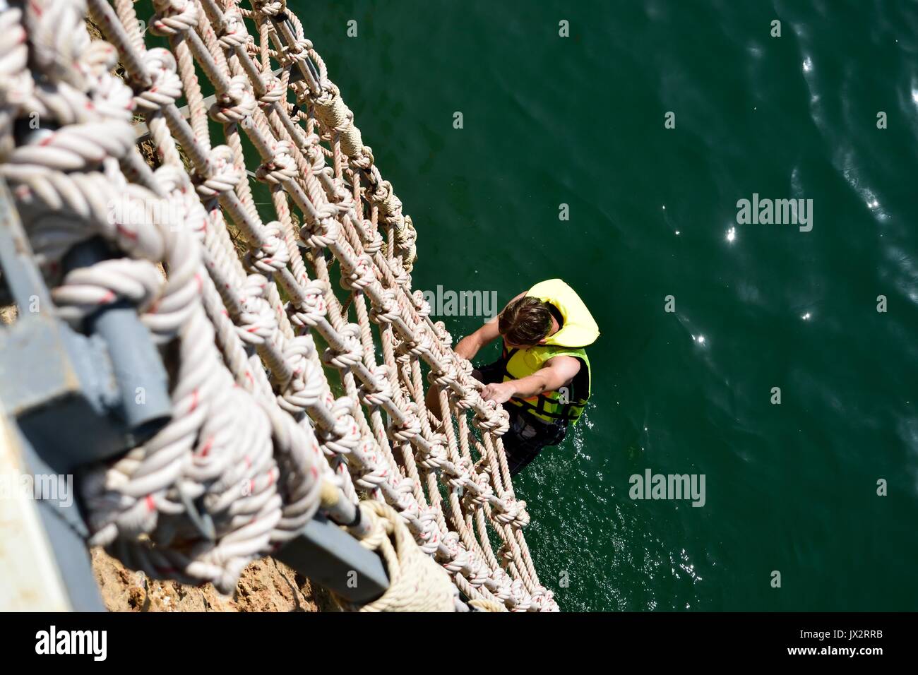 Man climbing a net Stock Photo - Alamy