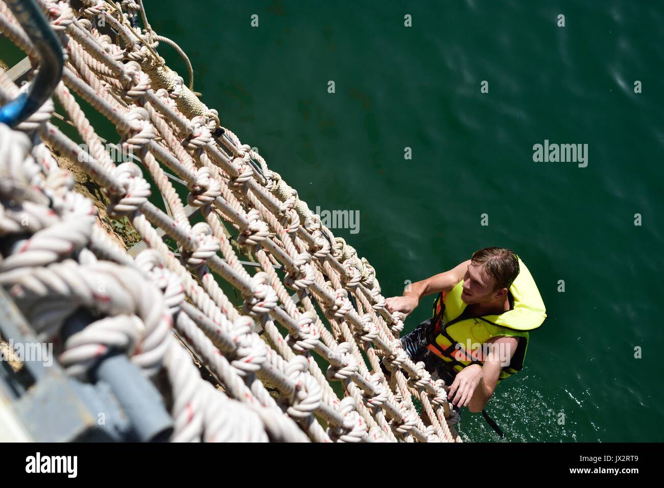 Man climbing a net Stock Photo - Alamy