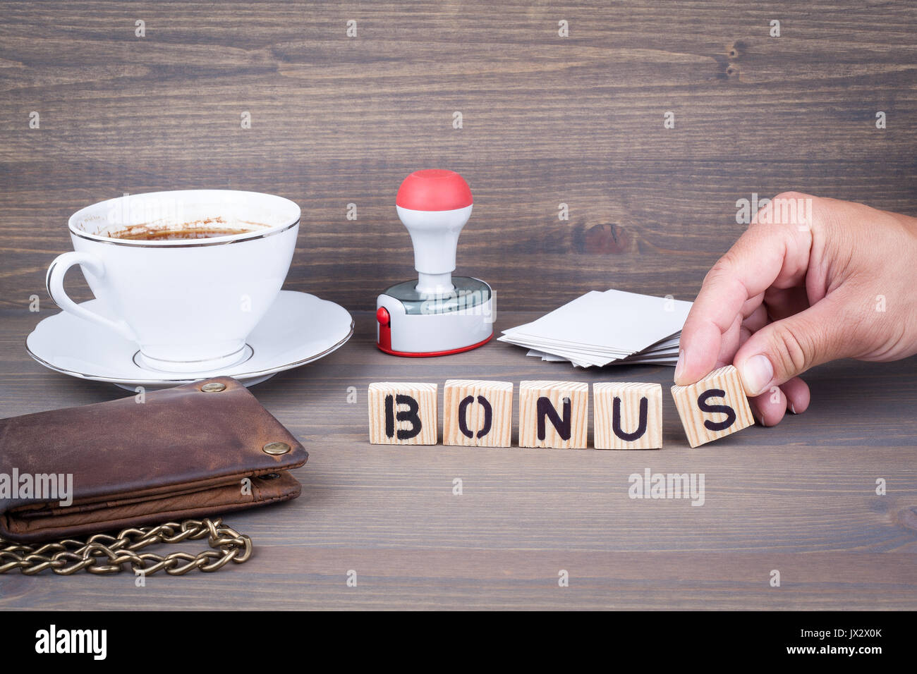 bonus. Wooden letters on dark background. Office desk Stock Photo - Alamy