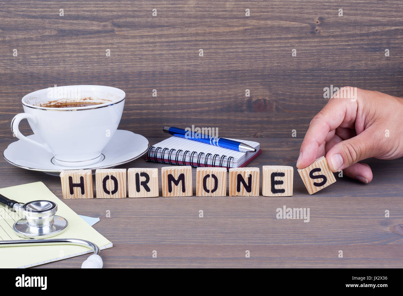 hormones. Wooden letters on dark background. Office desk Stock Photo ...