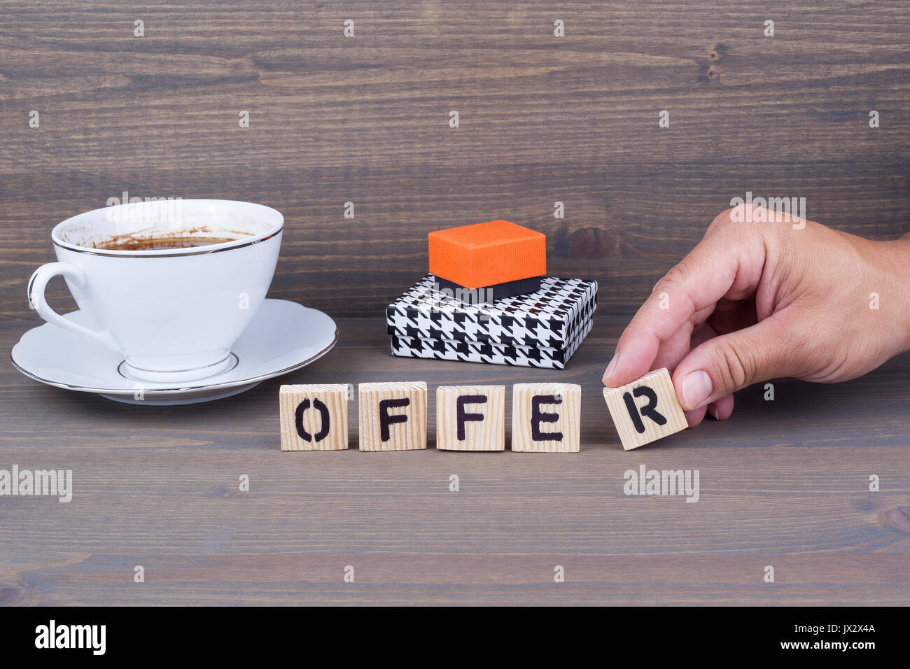 offer. Wooden letters on dark background. Office desk Stock Photo - Alamy