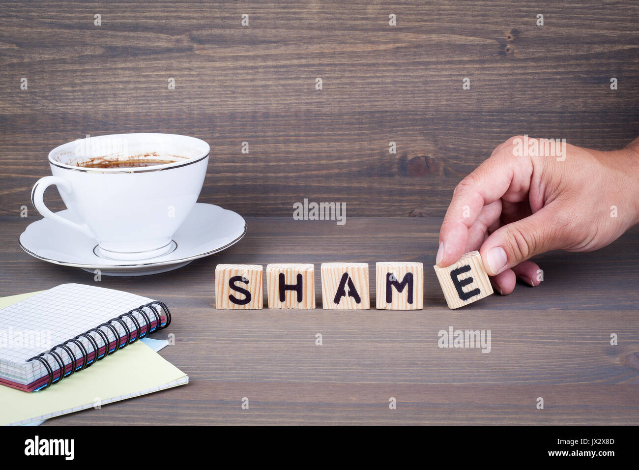 shame. Wooden letters on dark background. Office desk Stock Photo - Alamy