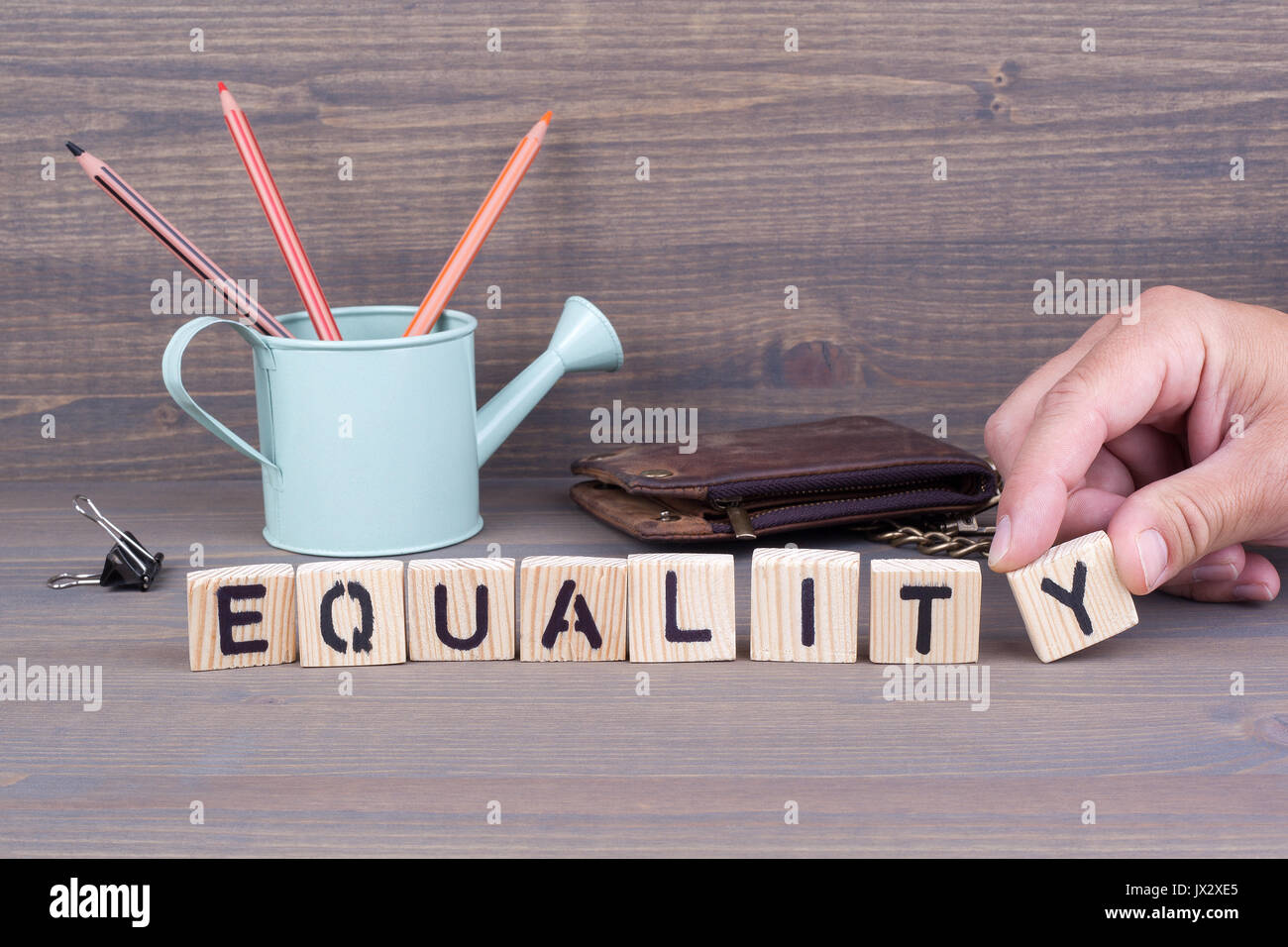 Equality concept.Wooden letters on dark background. Office desk Stock ...