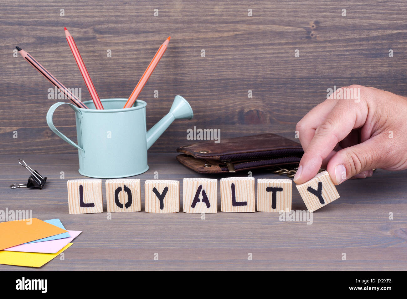 Loyalty concept.Wooden letters on dark background. Office desk Stock ...