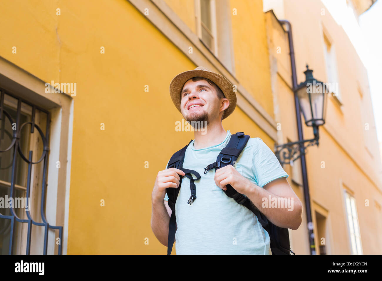 Handsome bearded tourist with backpack is making travel across city ...