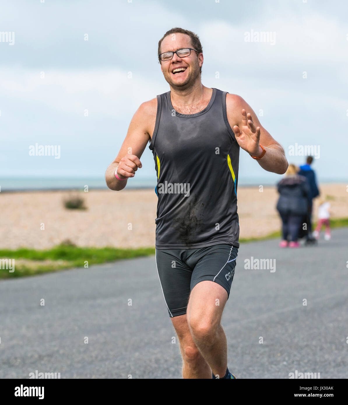 Man running as part of a running event along a seafront promenade Stock ...