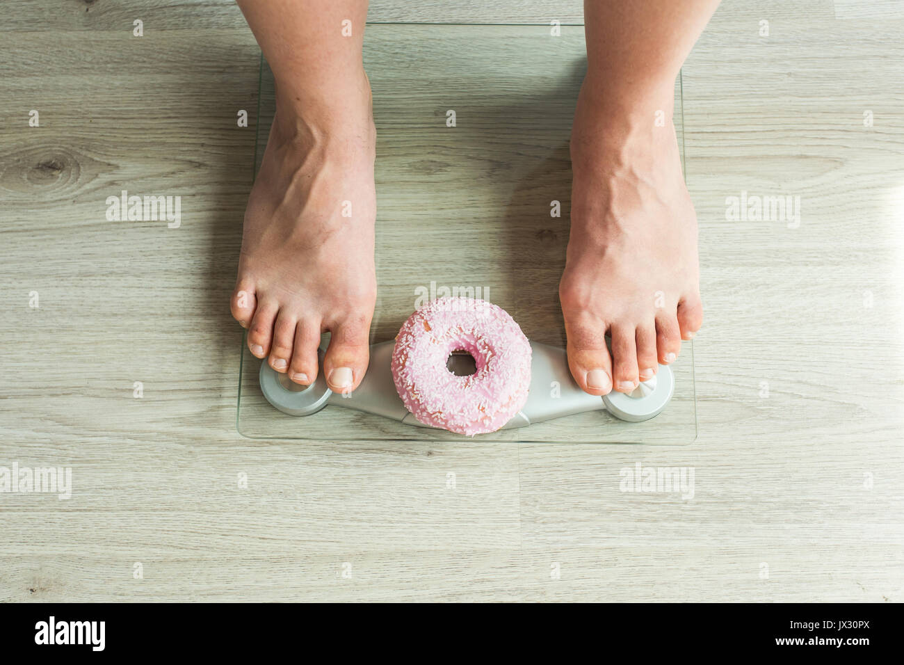 Diet Concept. Close-up of Woman's feet On Weighing Scale With Donut ...