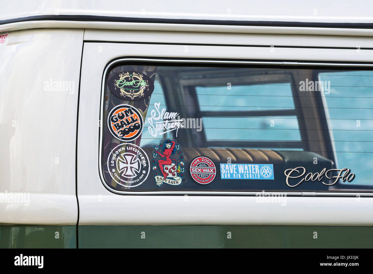 A closeup view of various stickers and signs on the window of a VW ...