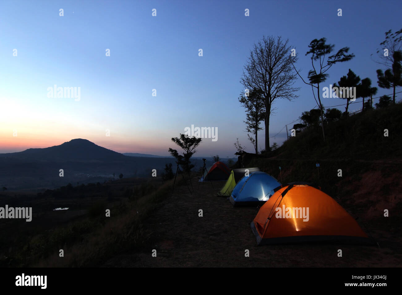 camping tents at twilight time with mountain background Stock Photo - Alamy