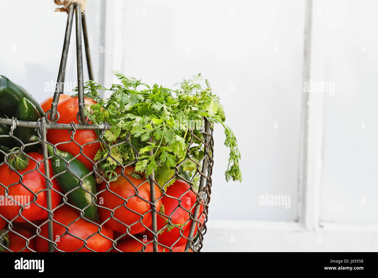 Ingredients for homemade salsa in an old country basket sitting in ...