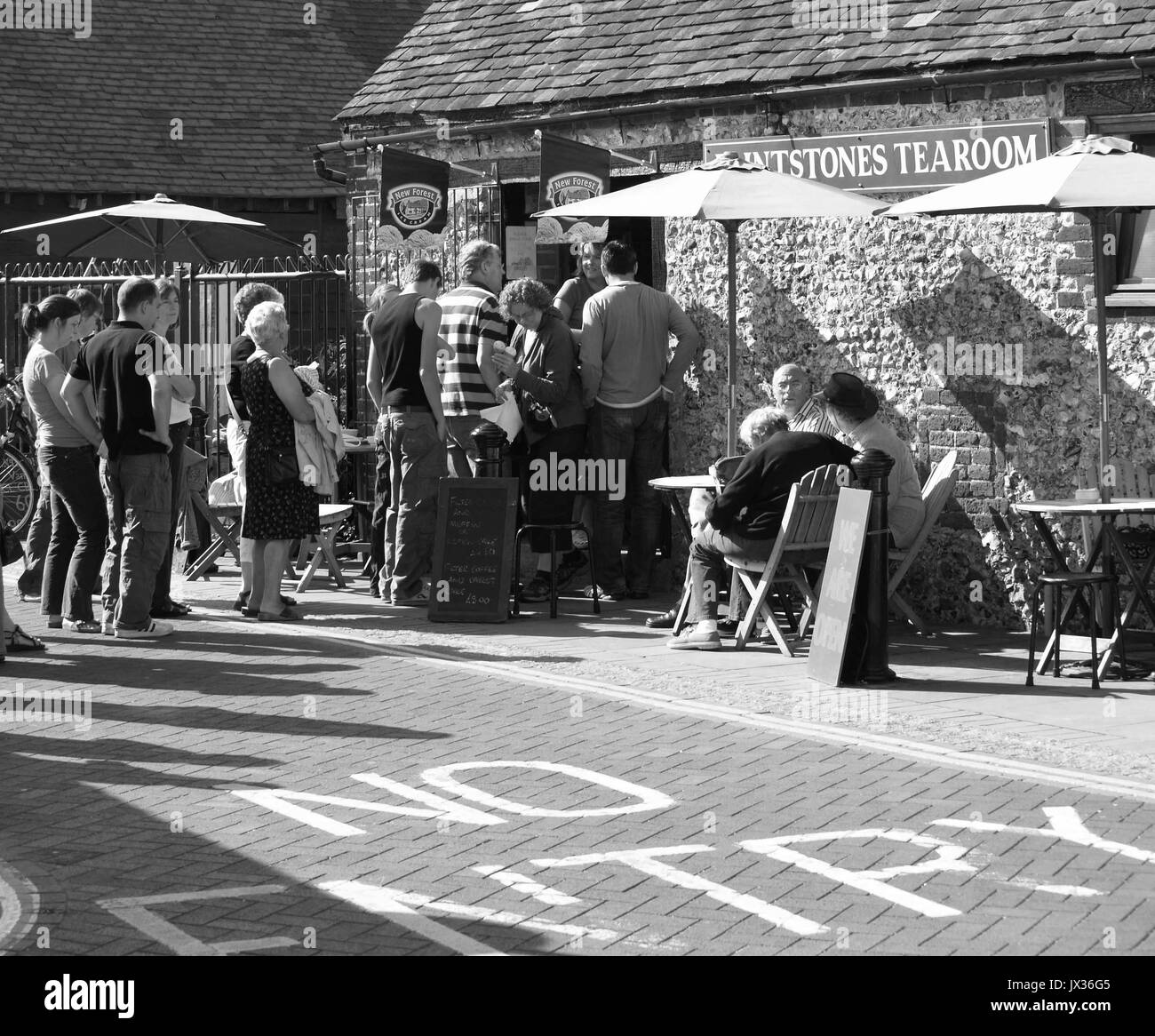 Typical queue outside Ice Cream shop at British Seaside town. Black and ...