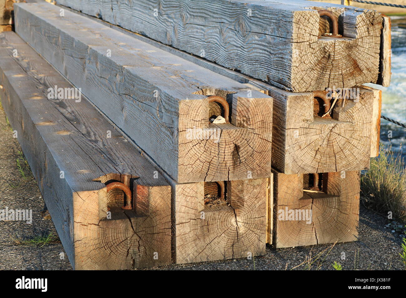 Stack 'em - long square wood logs used for water dams Stock Photo - Alamy