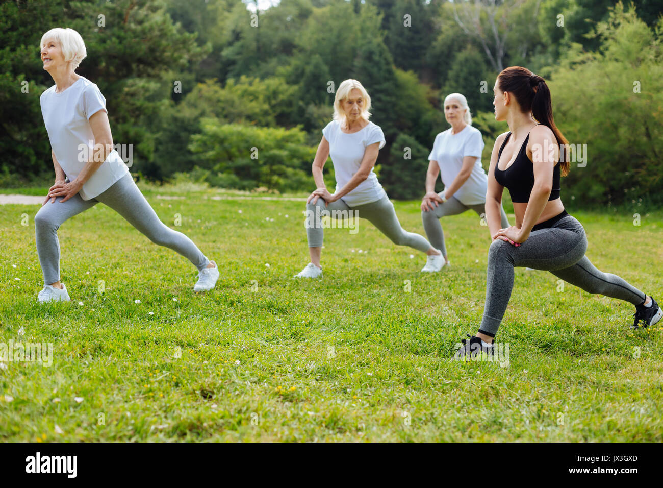 Serious trainer demonstrating new exercise Stock Photo - Alamy