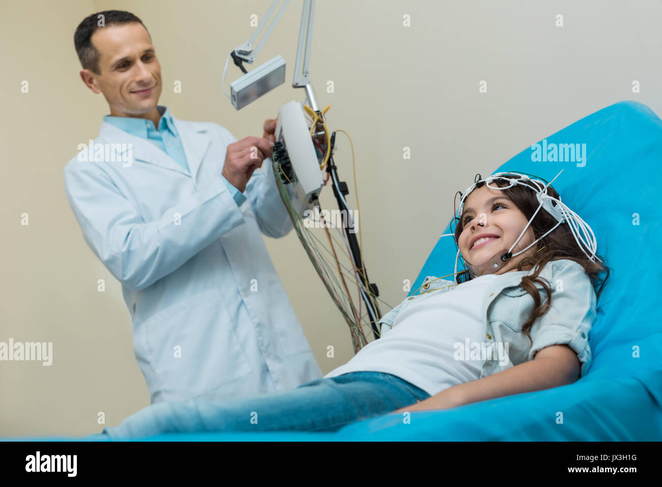 Medical specialist conducting encephalography of little girl Stock ...