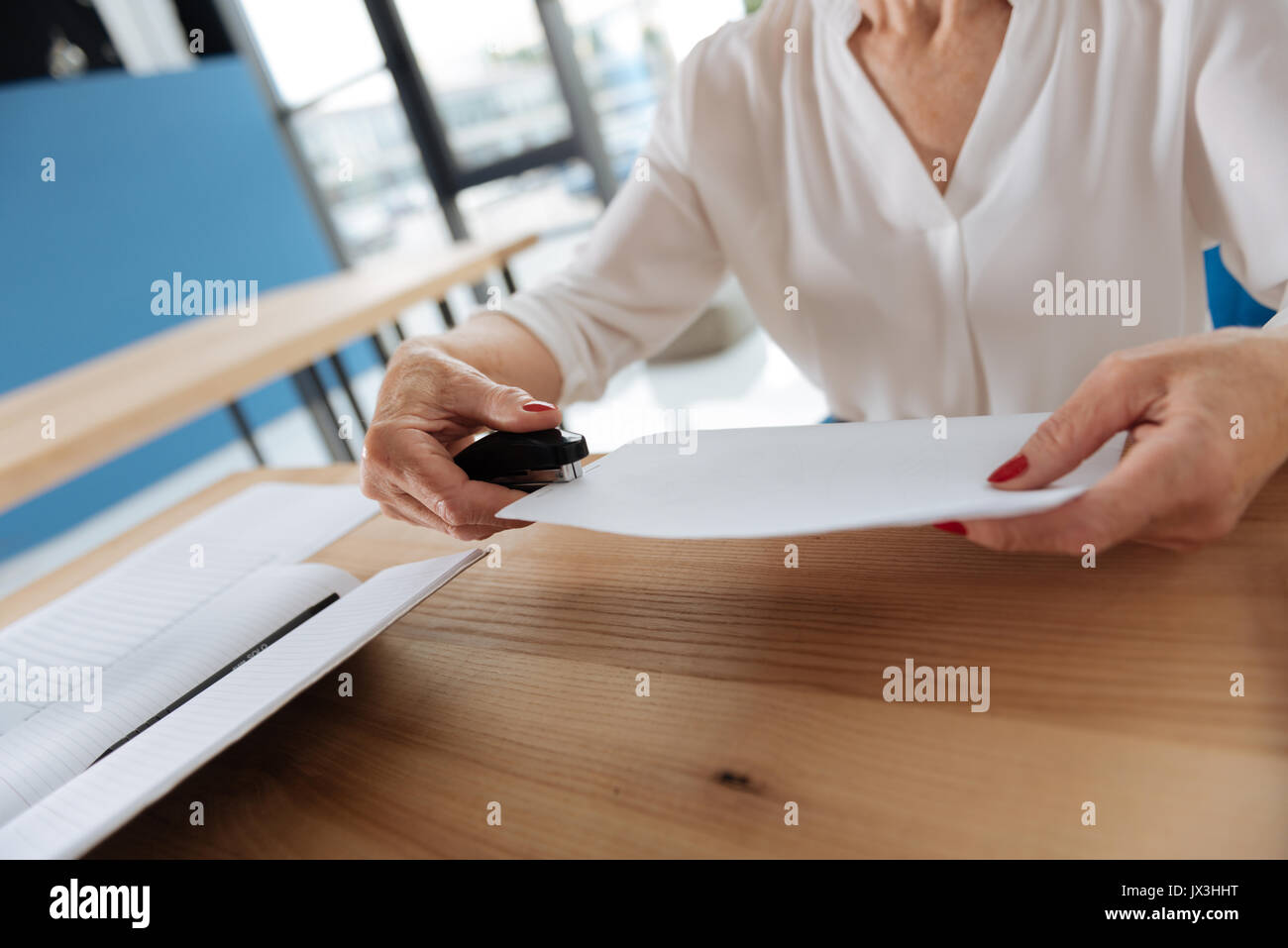 Close up of a stapler being in use Stock Photo - Alamy