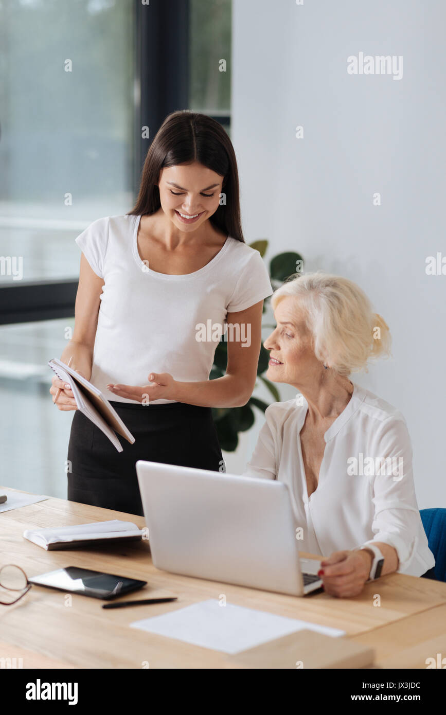Elderly woman talking to boss hi-res stock photography and images - Alamy