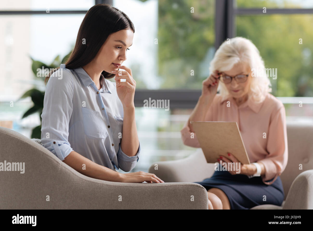 Smart serious woman applying for a job Stock Photo - Alamy
