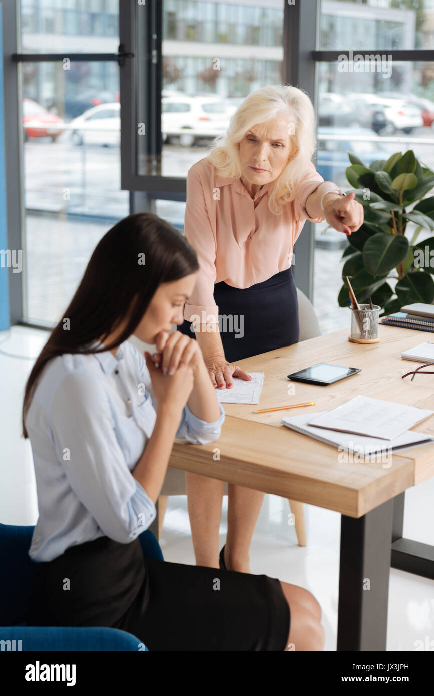 Angry cheerless woman firing her secretary Stock Photo - Alamy