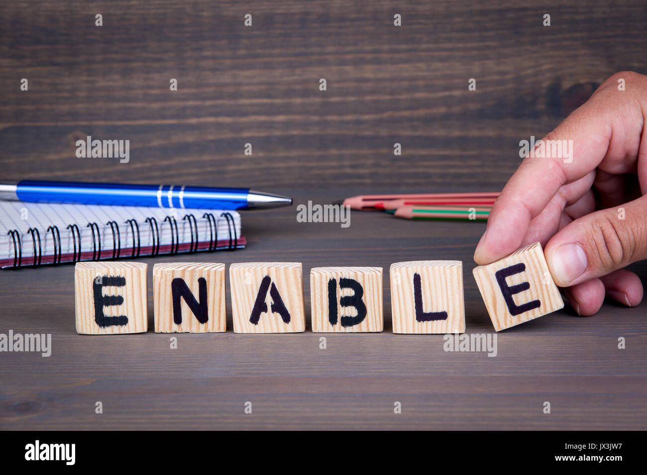 Enable. Wooden letters on dark background. Office desk Stock Photo - Alamy