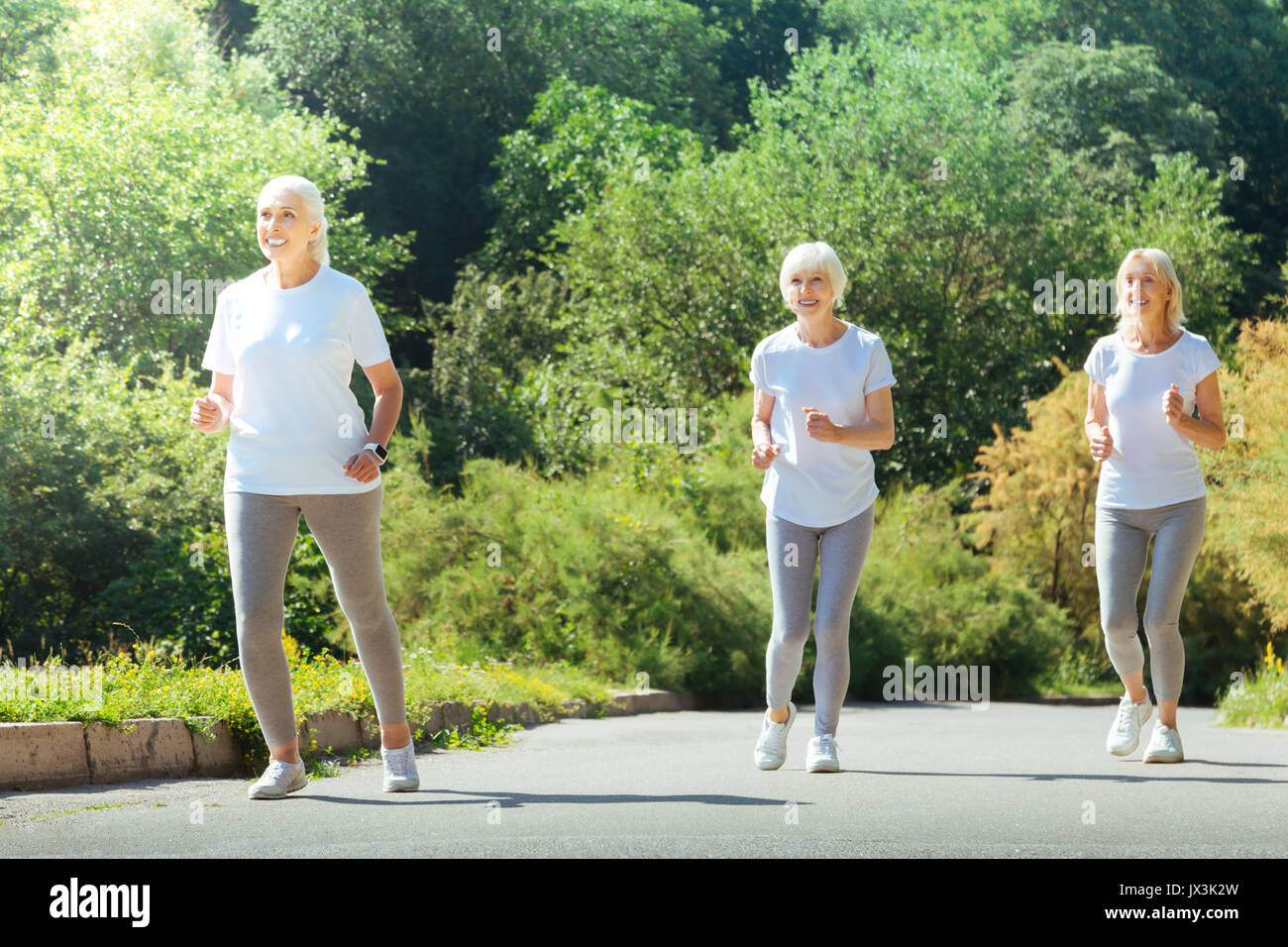 Three happy females running in one line Stock Photo - Alamy