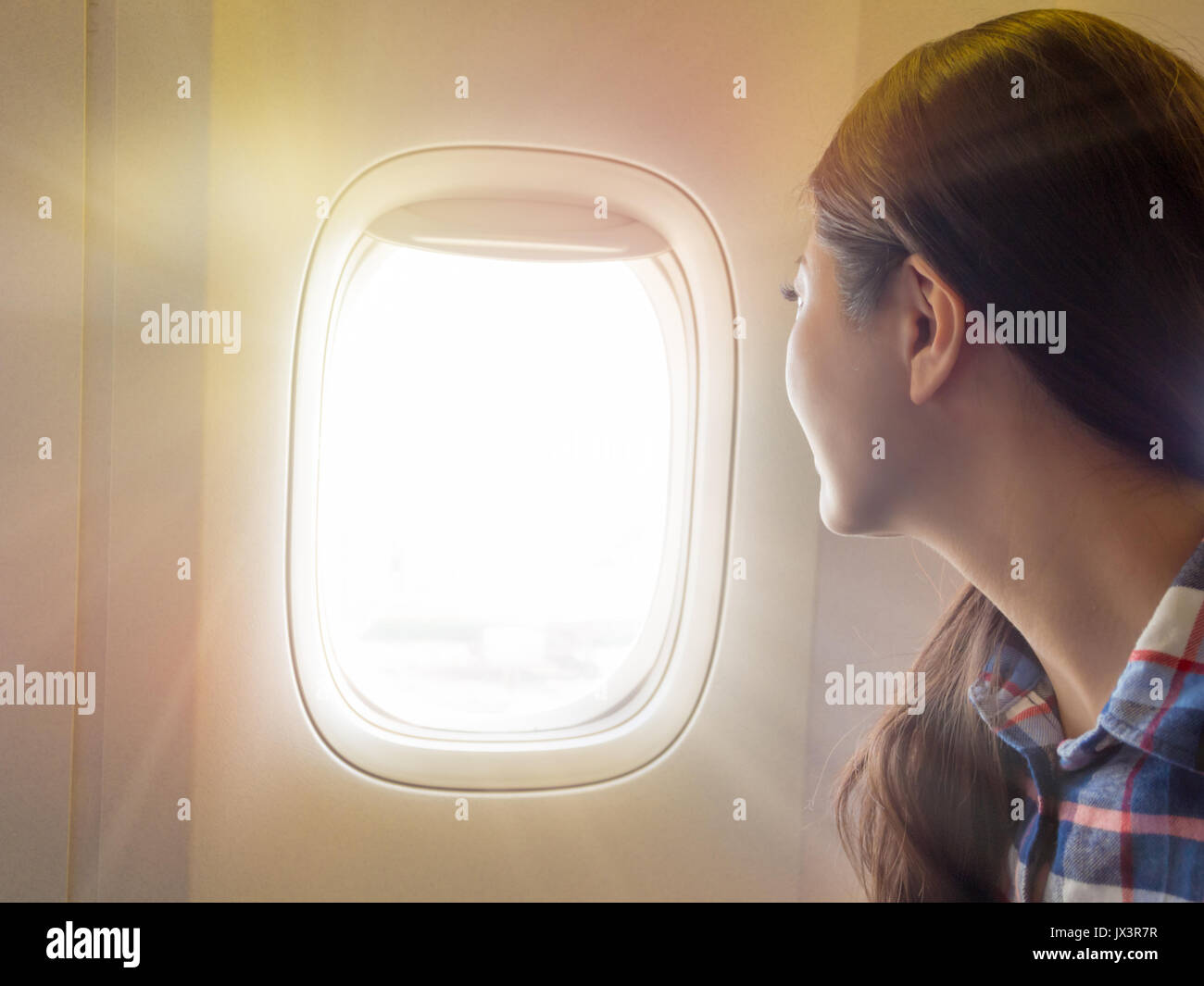 traveler in the airplane. international exchange student sitting at the ...
