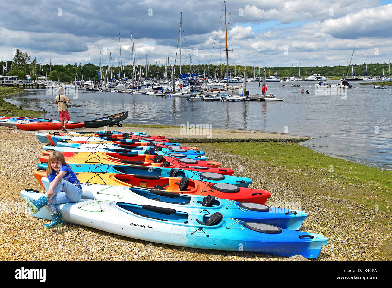 Child sat on Kayak along Beaulieu river at Bucklers Hard waterfront ...