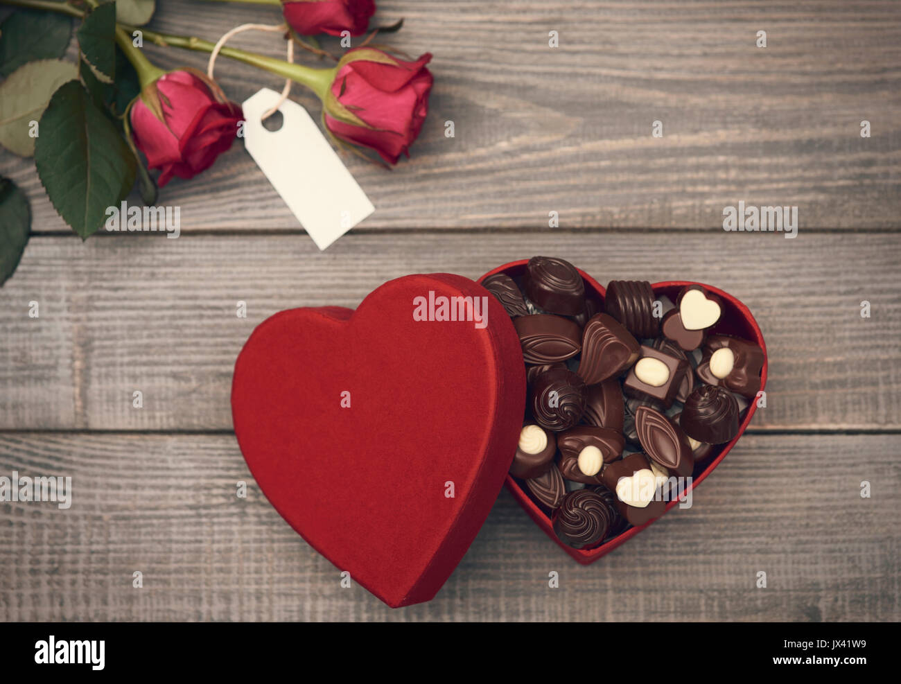 Roses and opened chocolate box Stock Photo - Alamy