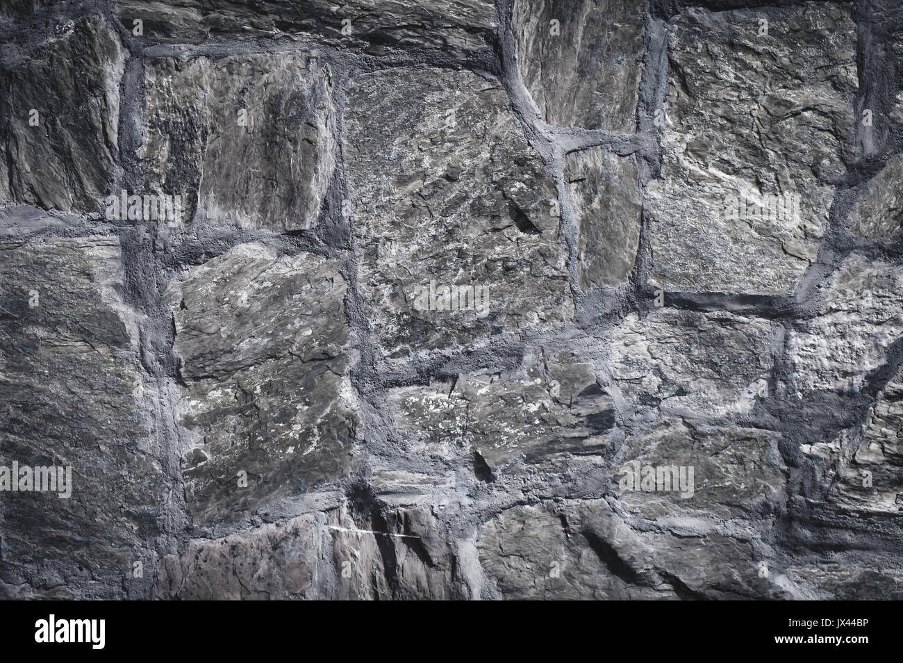 Old stone wall as background. A wall of rough round stones instead of ...