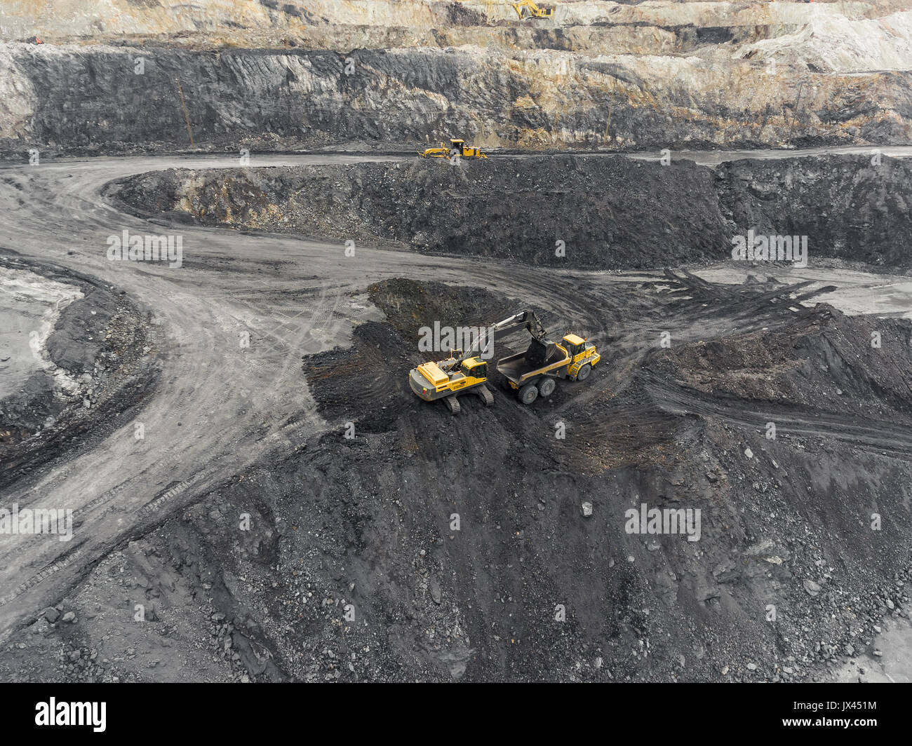 Aerial view open pit mine, loading of rock, mining coal, extractive ...