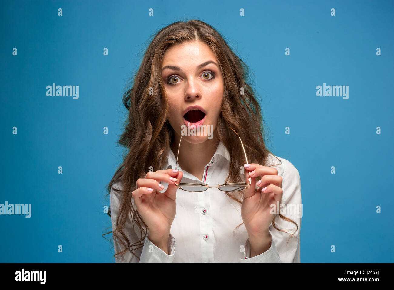 Portrait of young woman with shocked facial expression Stock Photo - Alamy