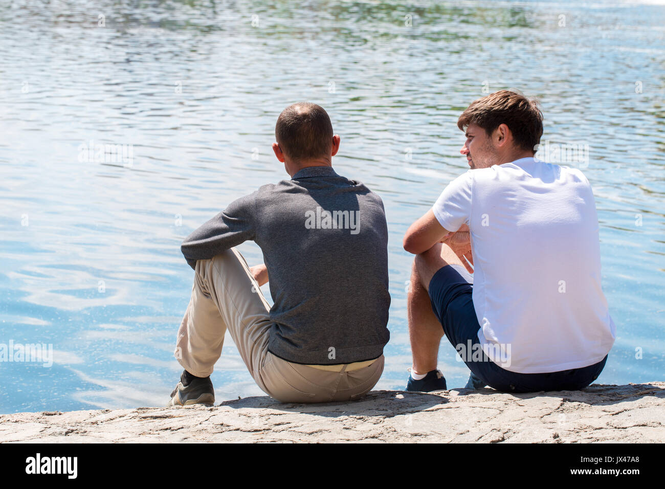 Two good friends communicate by the river Stock Photo - Alamy