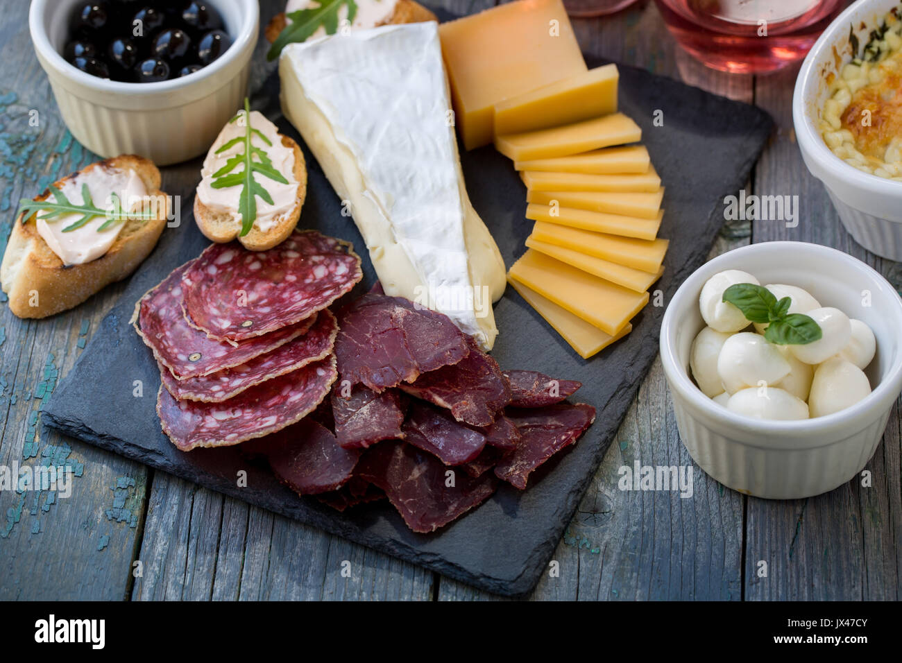 Board with basturma, salami,camembert, cheese, other delicacies and ...
