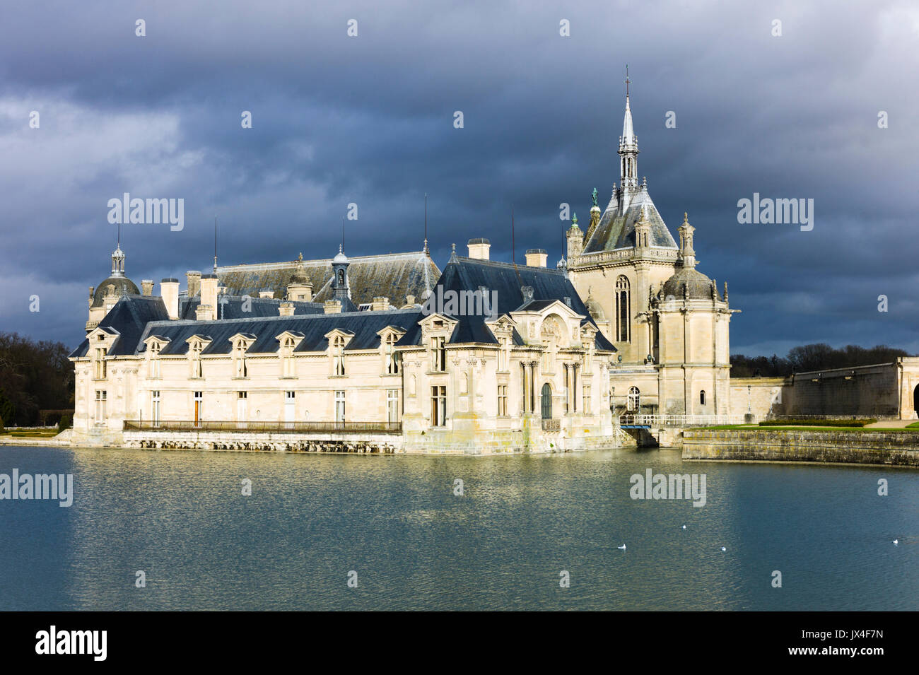 Palace of Chantilly in golden afternoon light Stock Photo - Alamy