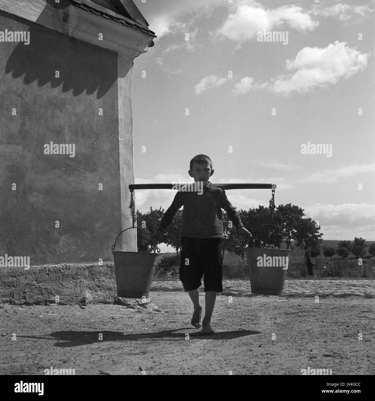 Boy Carrying Buckets High Resolution Stock Photography and Images - Alamy