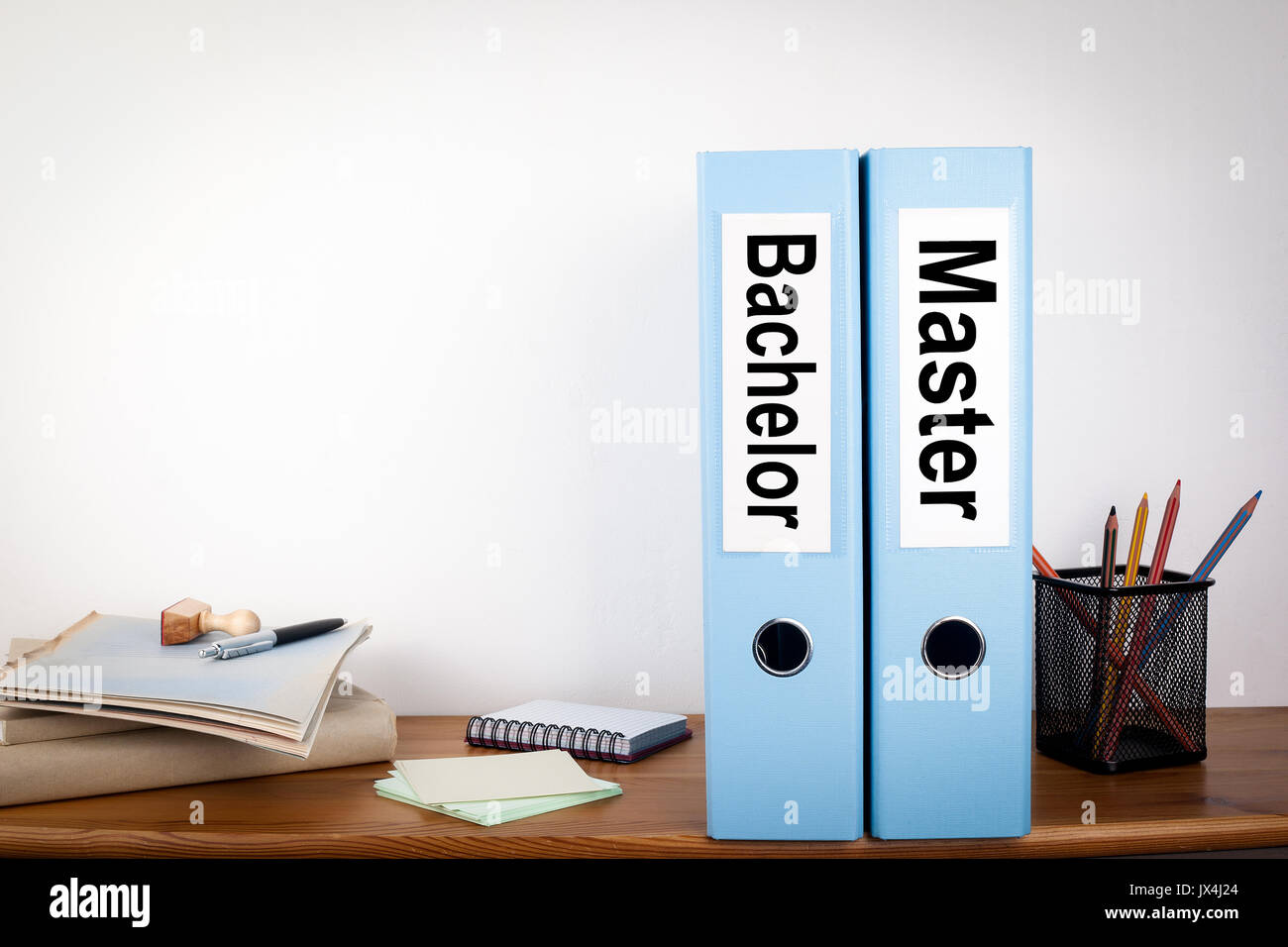 Bachelor and Master binders in the office. Stationery on a wooden shelf ...