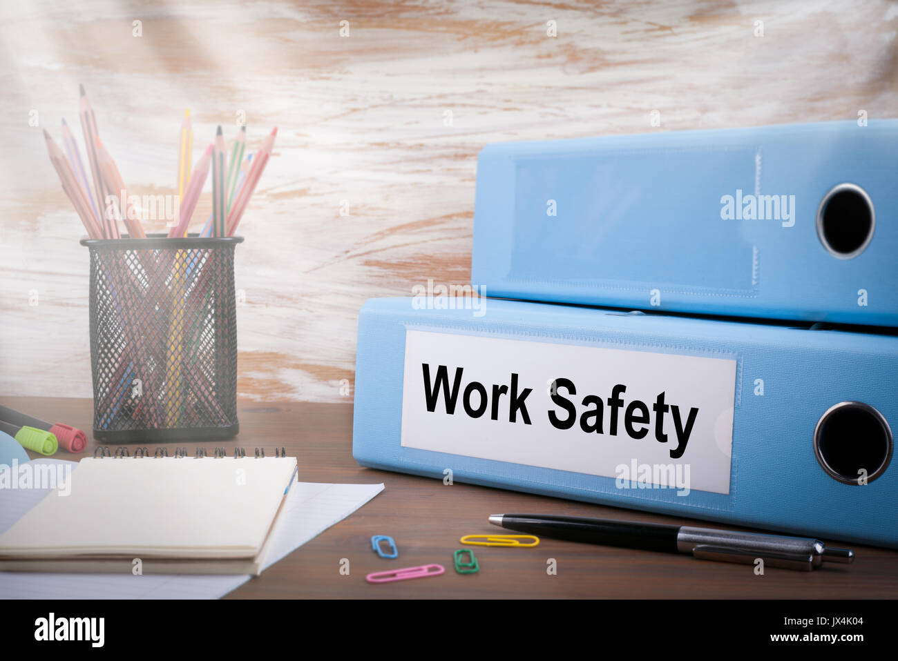 Work Safety, Office Binder on Wooden Desk. On the table colored pencils ...