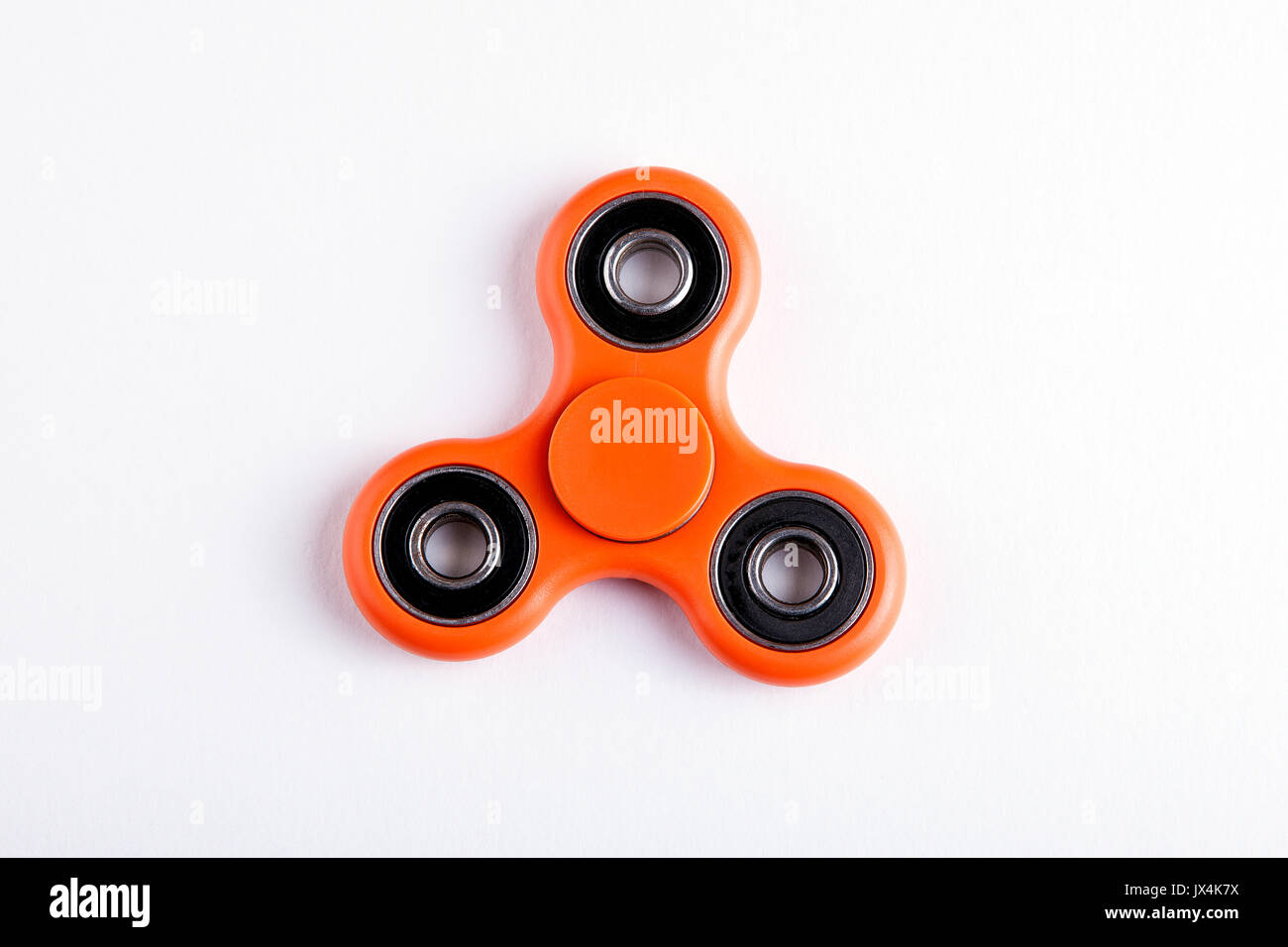 Orange fidget spinner stress relieving toy on white background Stock ...