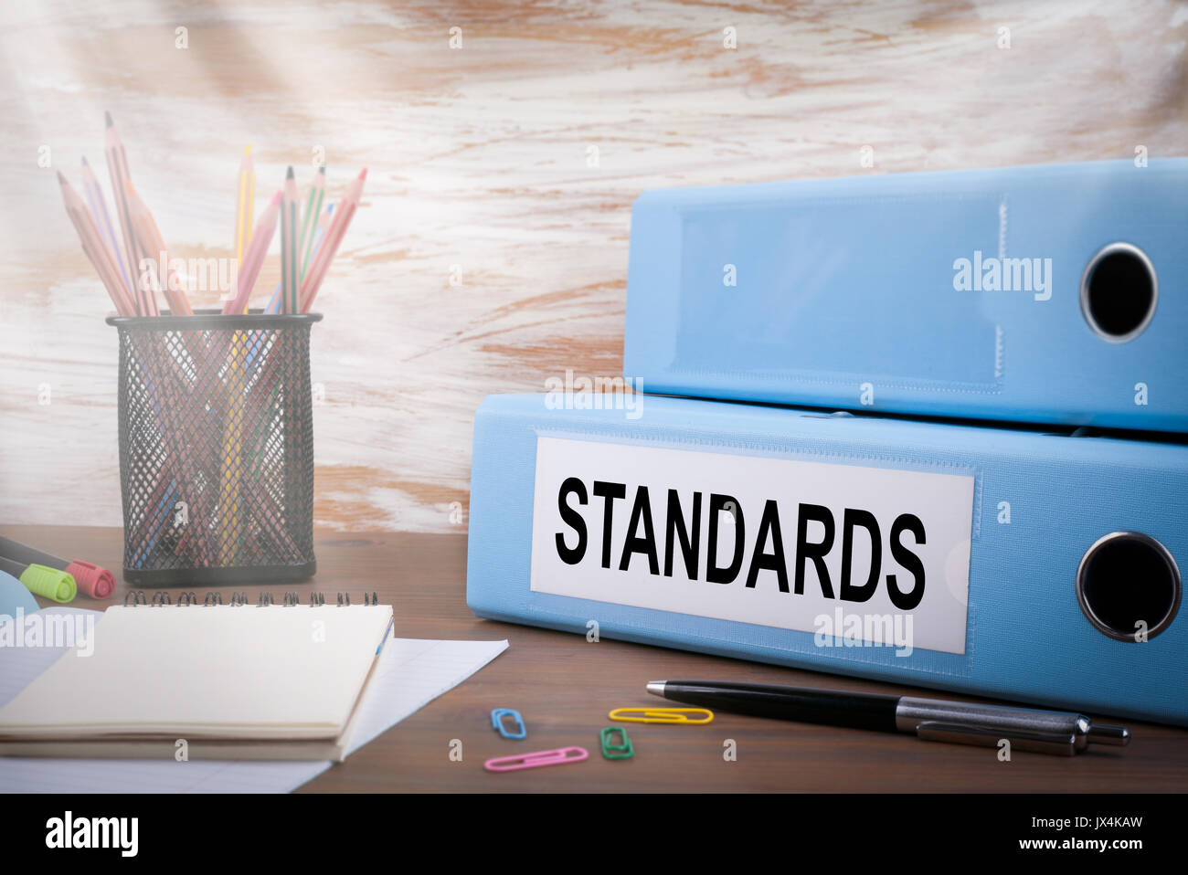 Standards, Office Binder on Wooden Desk. On the table colored pencils ...