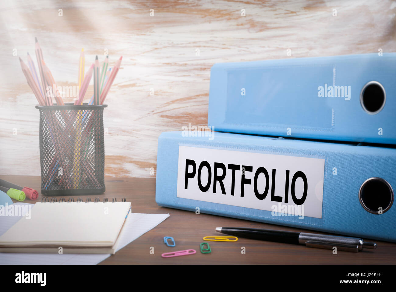 Portfolio, Office Binder on Wooden Desk. On the table colored pencils ...