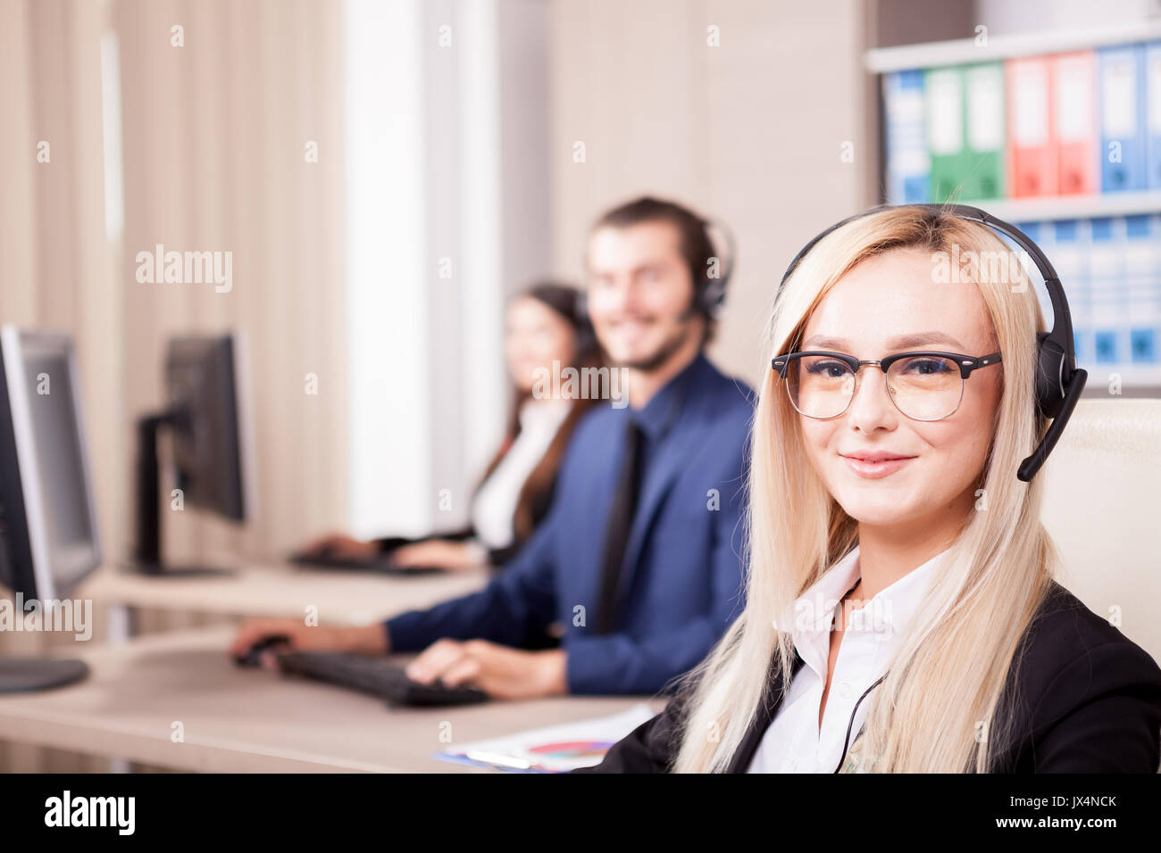 Beautiful blonde from customer support line in office working Stock ...