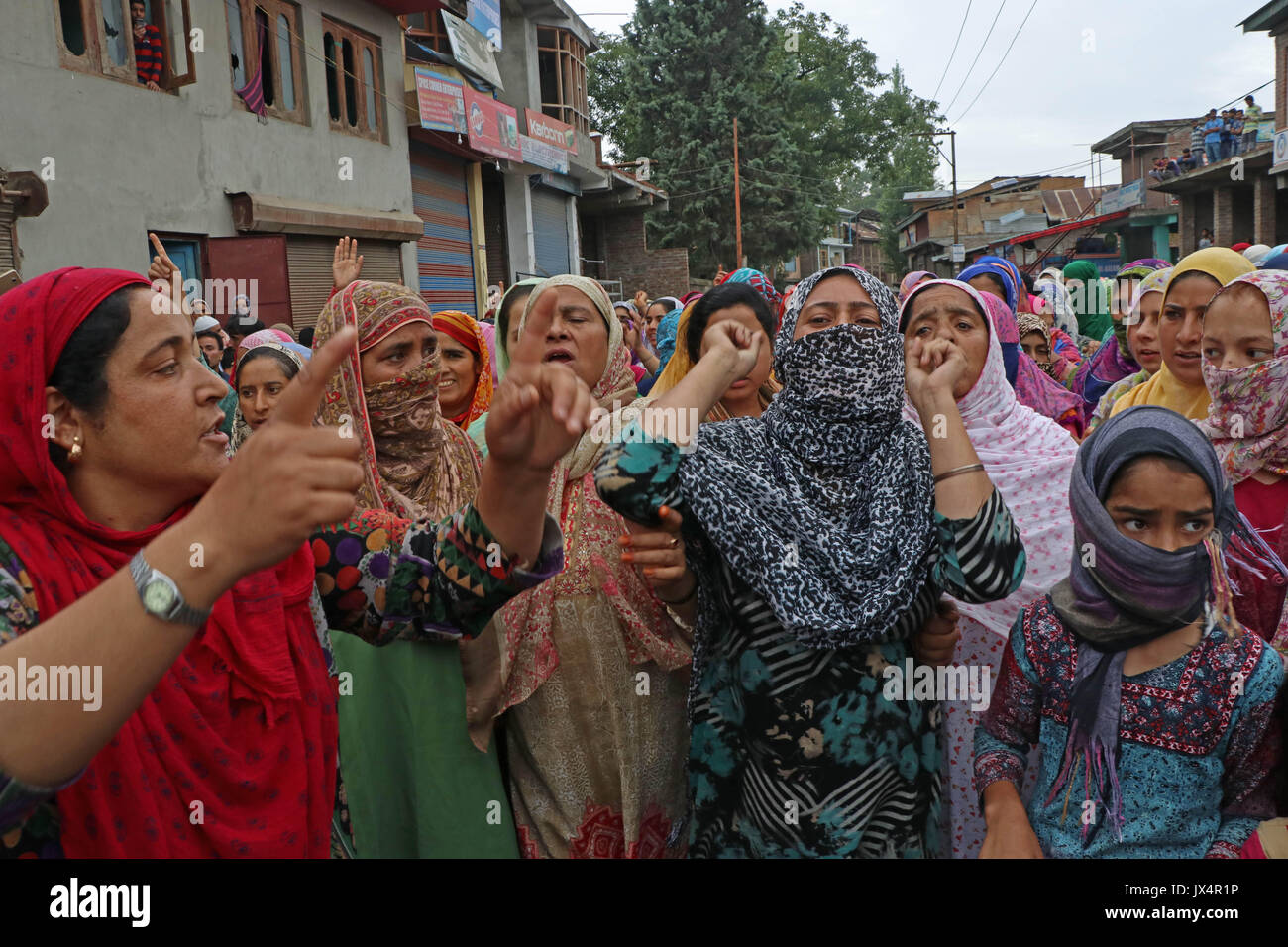 Protesters shout slogan during the funeral of procession of slain Hizb ...
