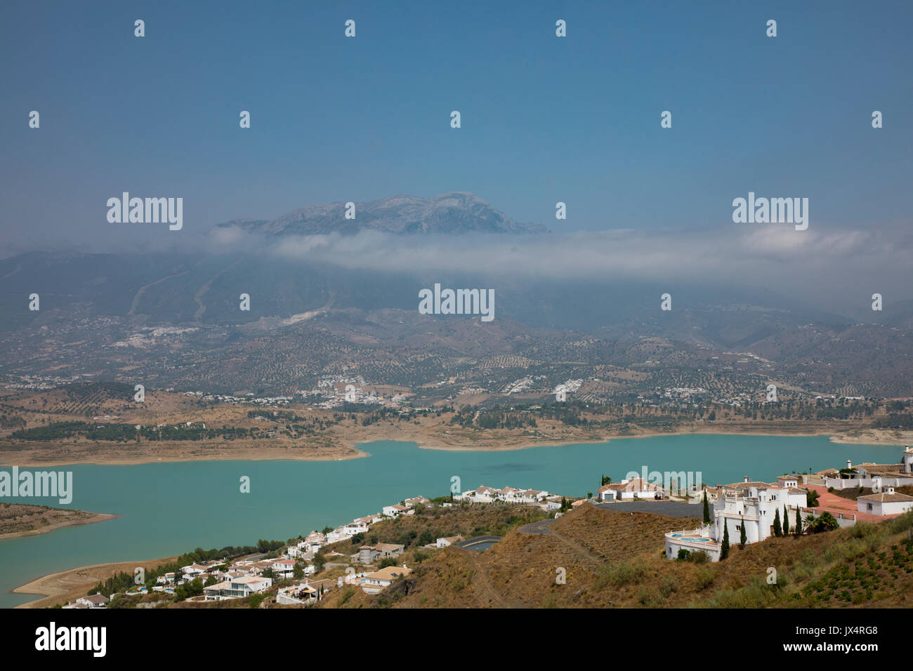 A view over a Spanish lake and some lovely houses and the tall mounting ...