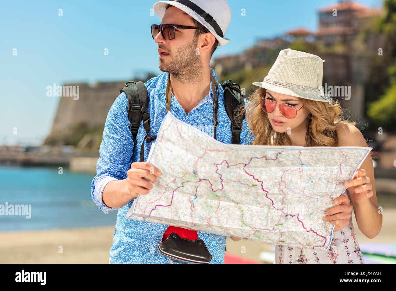 Couple tourist traveling and using map. Couple tourist exploring a city ...