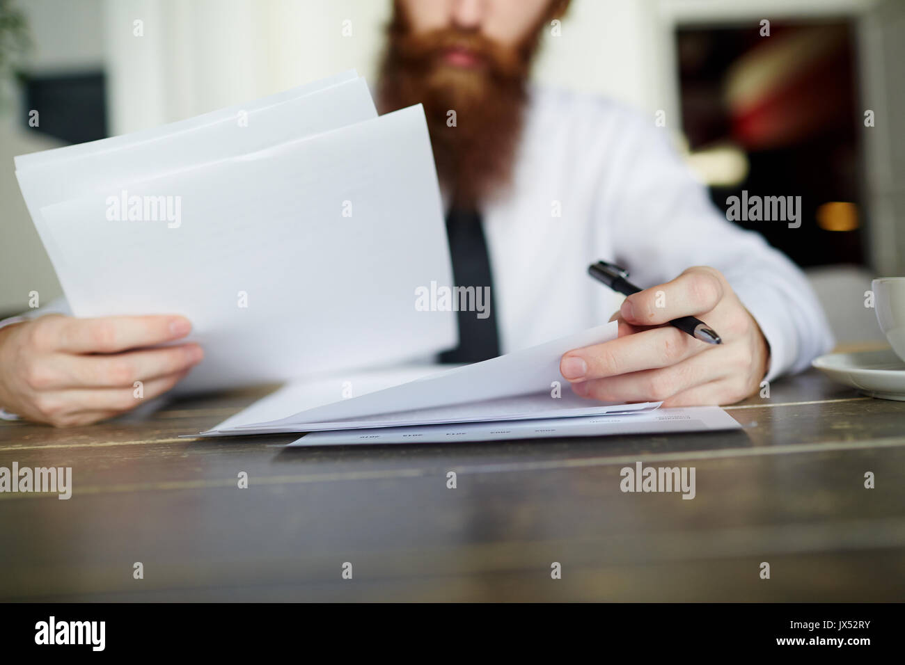 Reading business papers Stock Photo - Alamy