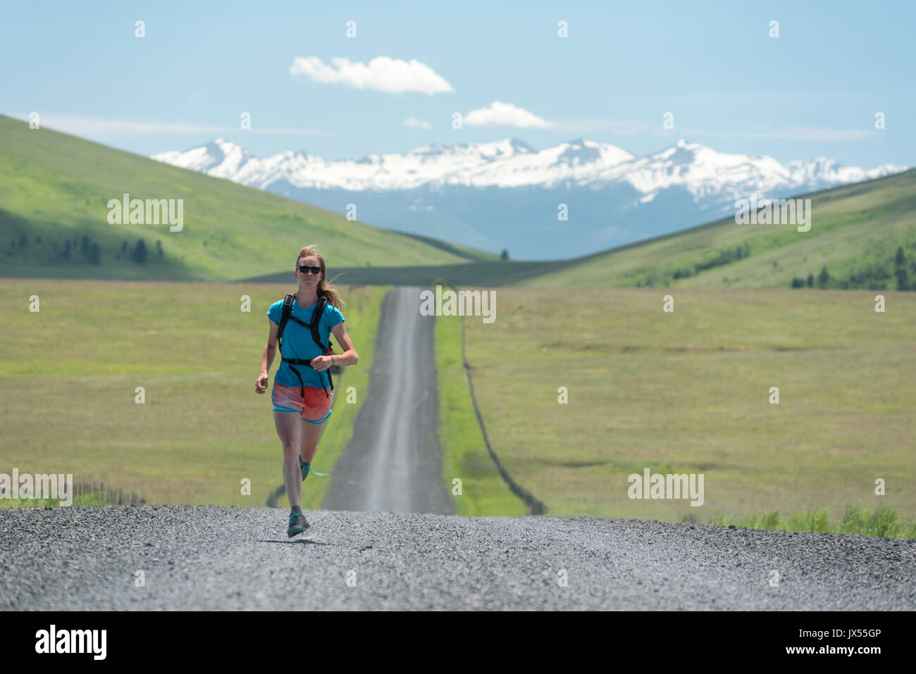 Female runner running on road hi-res stock photography and images - Alamy