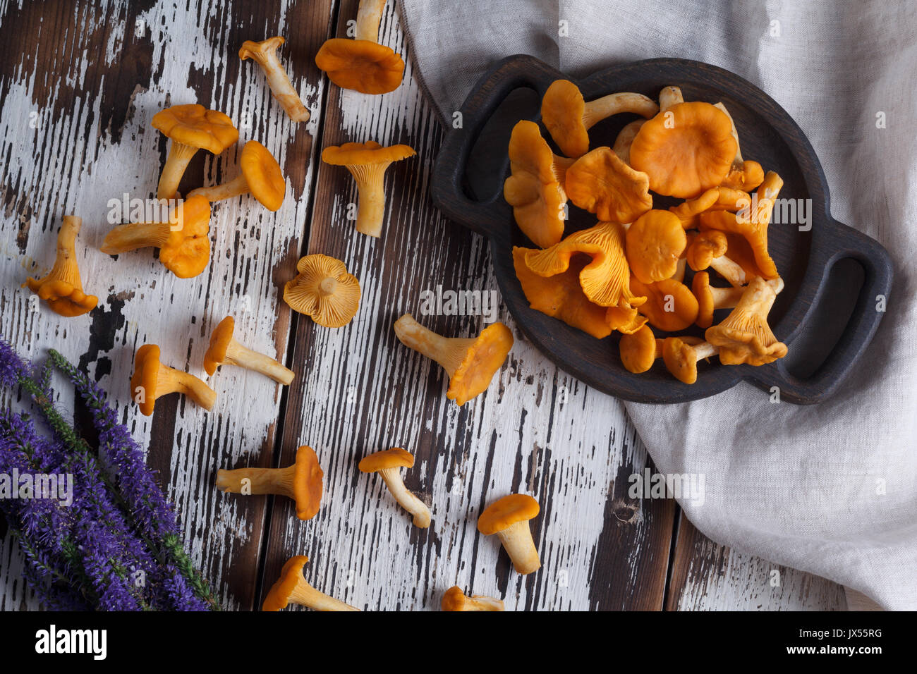 Fresh mushrooms chanterelle on a wooden background. Rustic Stock Photo ...