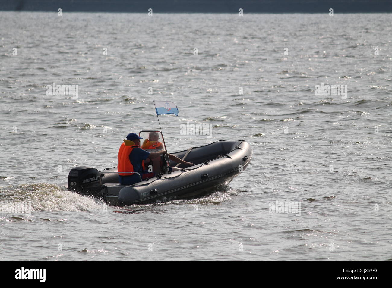 two brave and strong rescuer in fast boat under flag on Viliya sea ...
