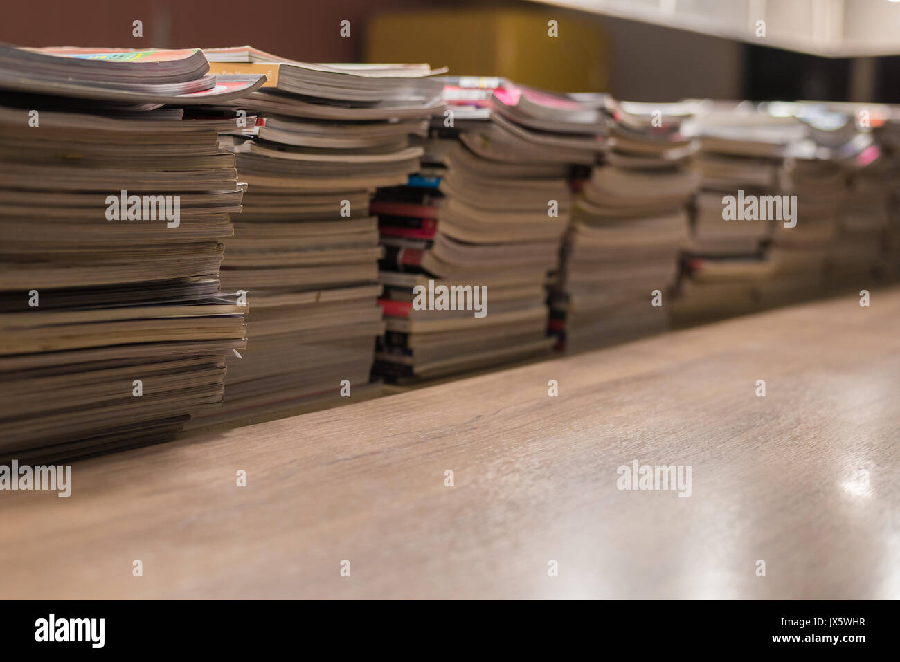 focus on book and magazine stack arrangement background on wooden table ...