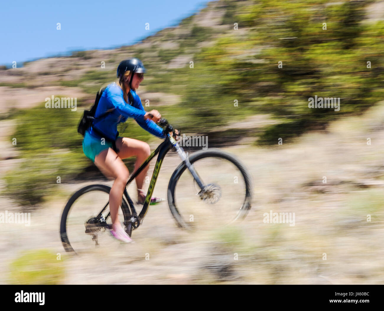 Female cyclist competes in the Fibark Festival mountain bike race ...